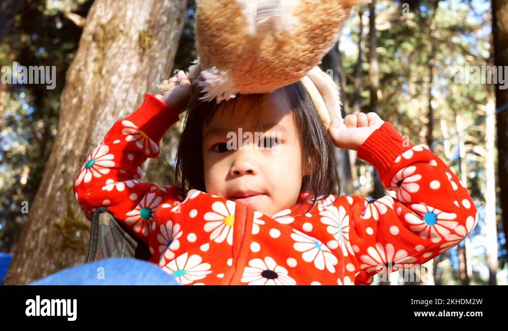 Asian little child girl sitting on the chair while going camping at ...