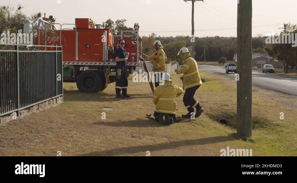 NSW Rural Fire Service firefighters refilling their water supply from a ...
