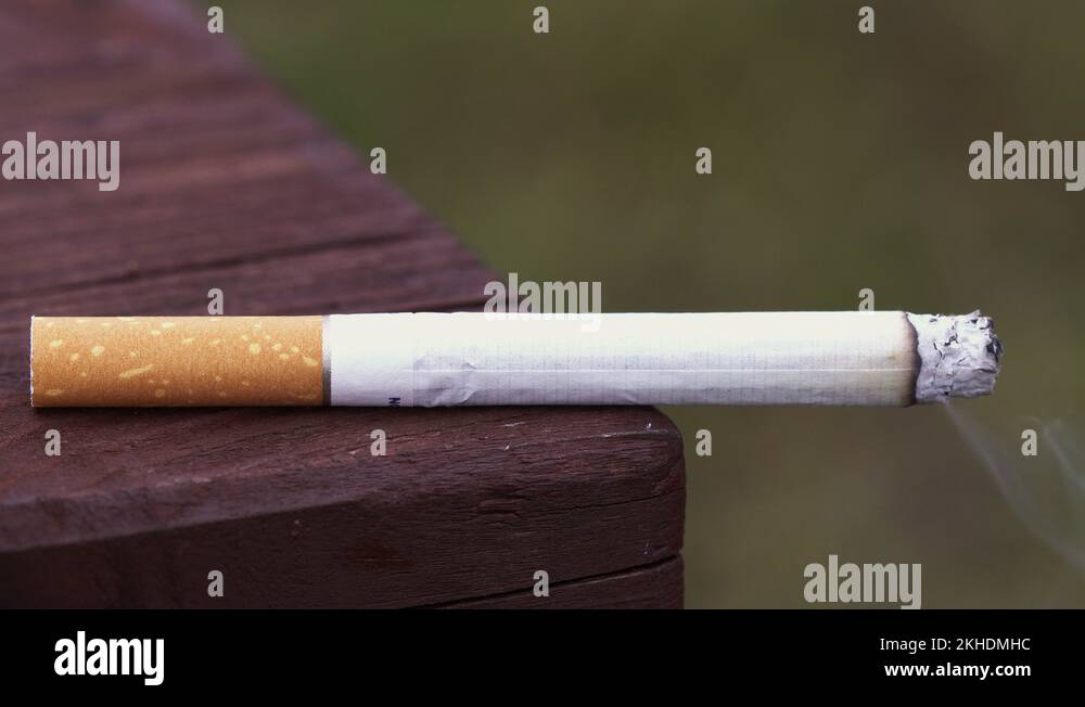 Cigarette on the bench in public place Stock Video Footage - Alamy