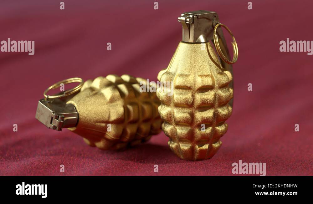 MK2 hand grenades. Two golden pineapple grenades on the red velvet ...