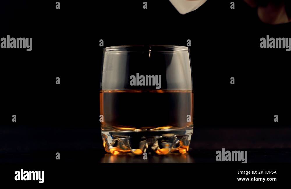 Throwing Ice Into Glass With Whiskey.Throw Ice Cube In Rum Or Cognac ...