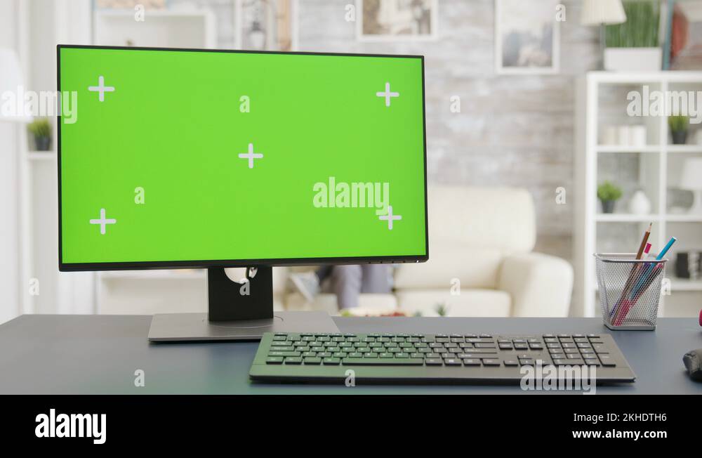 PC screen with isolated mock-up green screen display in bright living ...