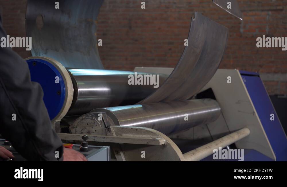 Pressure turns sheet of metal into pipe, workshop at metal rolling ...