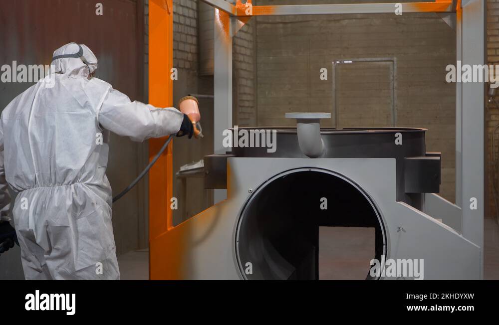 Spray gun, industrial painting, man in chemical protection suit ...