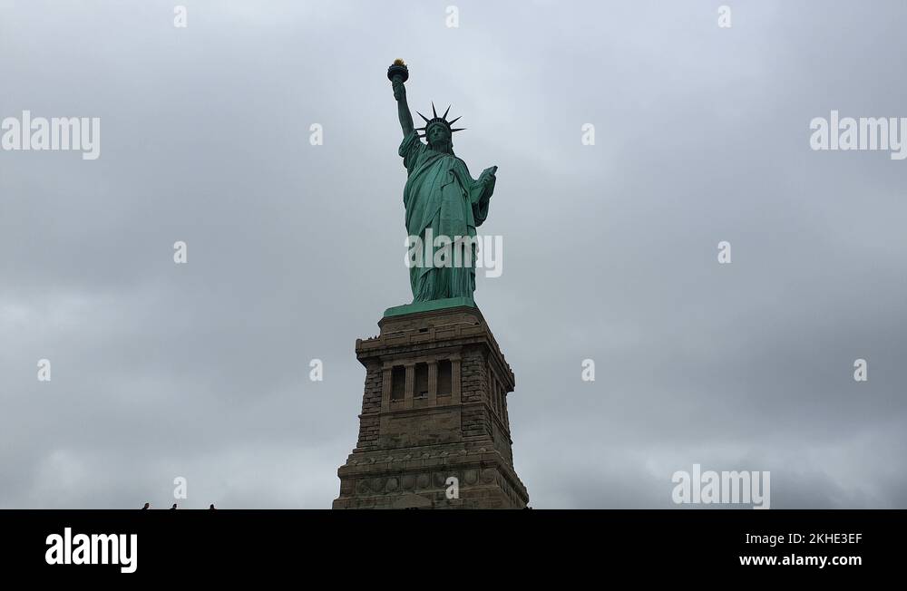 Statue of Liberty and pedestal shot from a low angle starting the ...