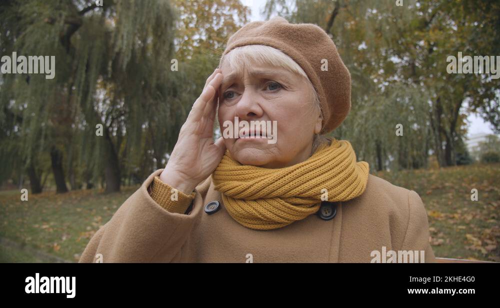 Confused old lady touching head, memory loss in street, elderly health ...