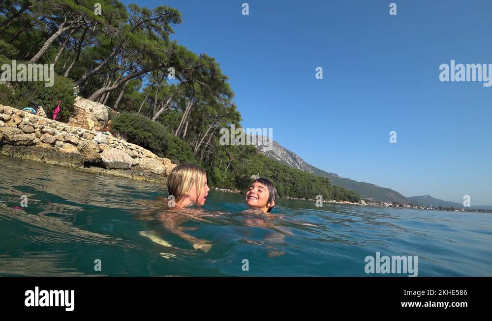 Two children dive in the sea holding hands Stock Video Footage - Alamy
