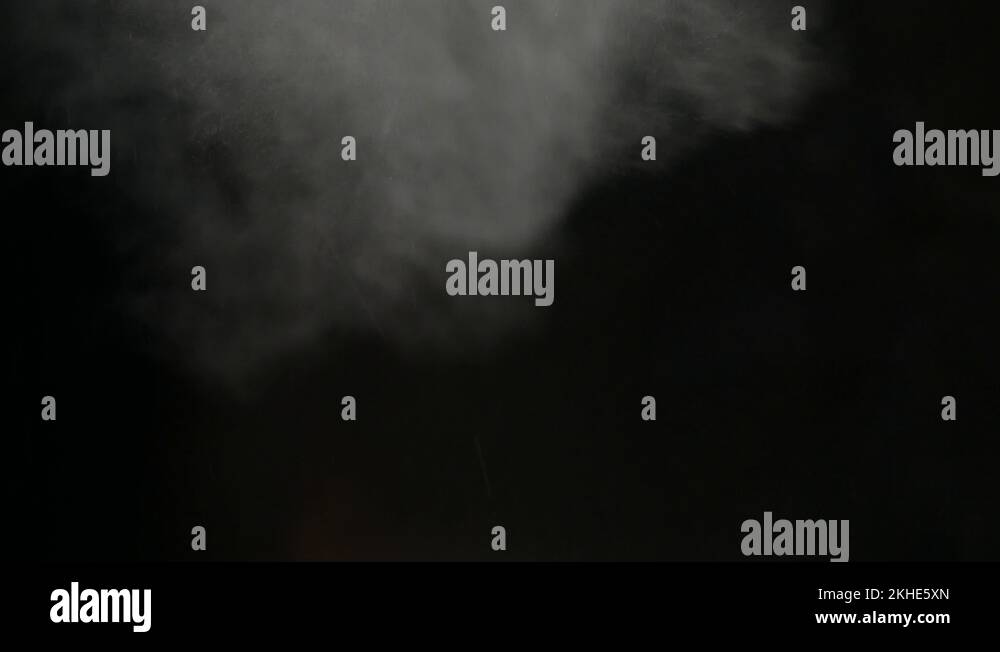 White talcum powder explosion on black background. Smoke background ...