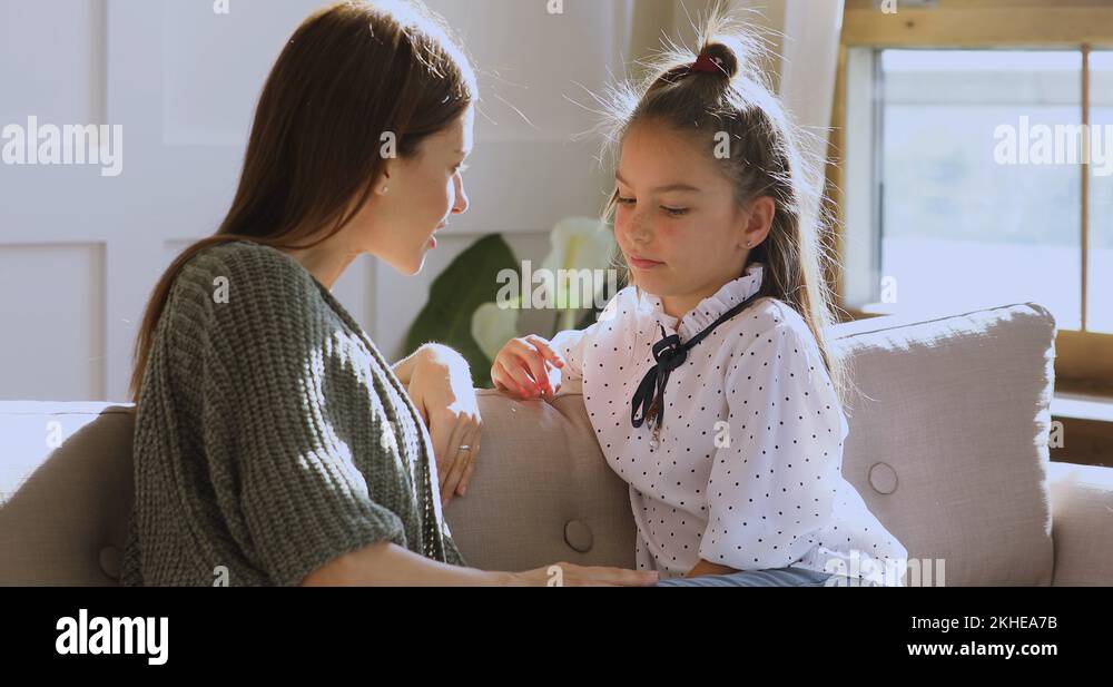 Caring mum talking with school child daughter sit on sofa Stock Video ...