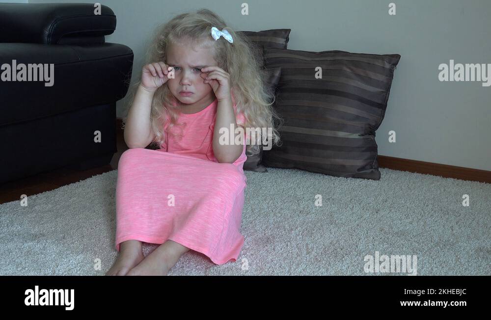 Cute irritable girl turn off her back. Adorable sad child with curly ...