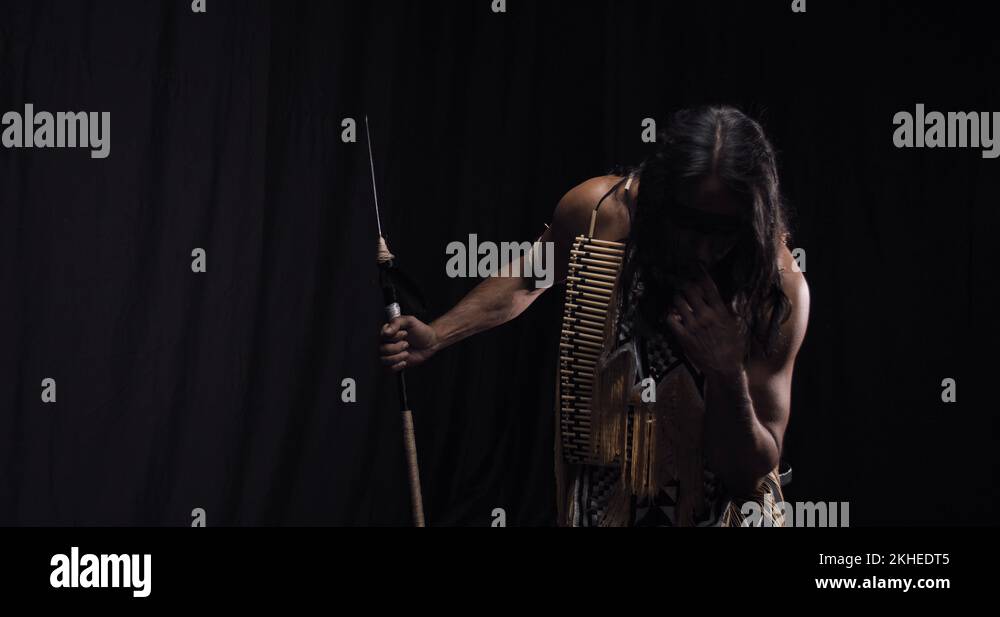 Sad native american indian with his head down, wearing traditional ...