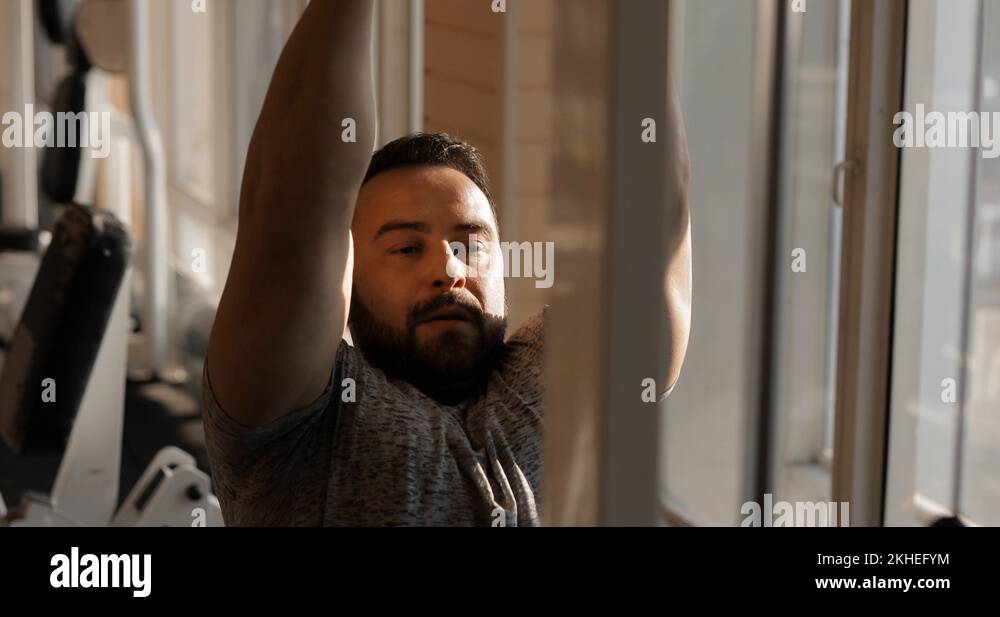 Man exercising in a gym making his latissimus dorsi muscles more ...