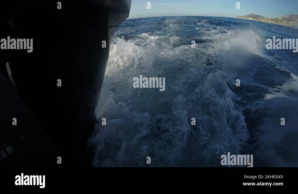 Churning water and wake coming off outboard motor on boat Stock Video ...