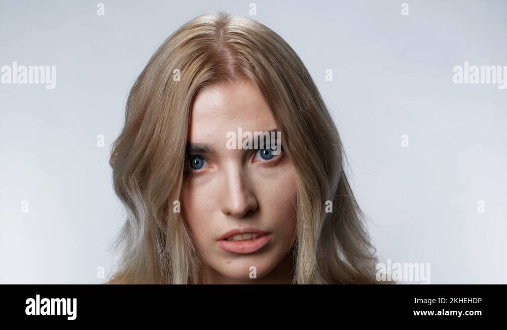 Aggressive pretty crazy girl looking at camera face sight close up ...