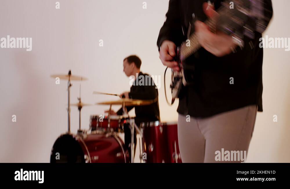 A musical band of four people playing song in the bright studio - The ...
