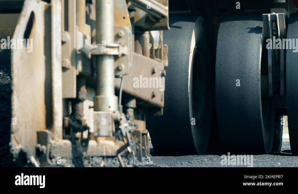 Wheels of an asphalt-placing vehicles in a front view. Road ...