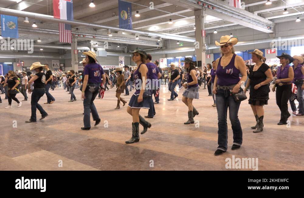 Women dancing line dance, dancers having fun at old west country show ...