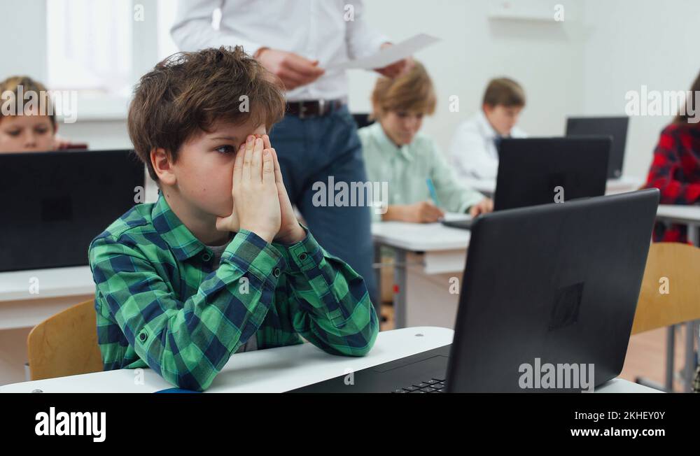 Education at modern school, schoolboy got a bad grade on test work, sad ...