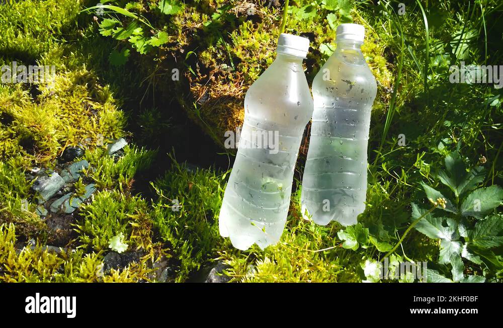 Two clear plastic bottles of clean water with a white cap Stock Video ...