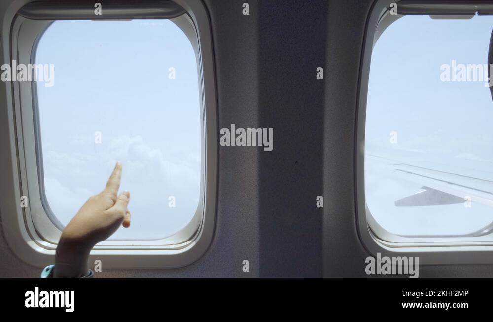 Girl pointing at sky through the airplane window Stock Video Footage ...