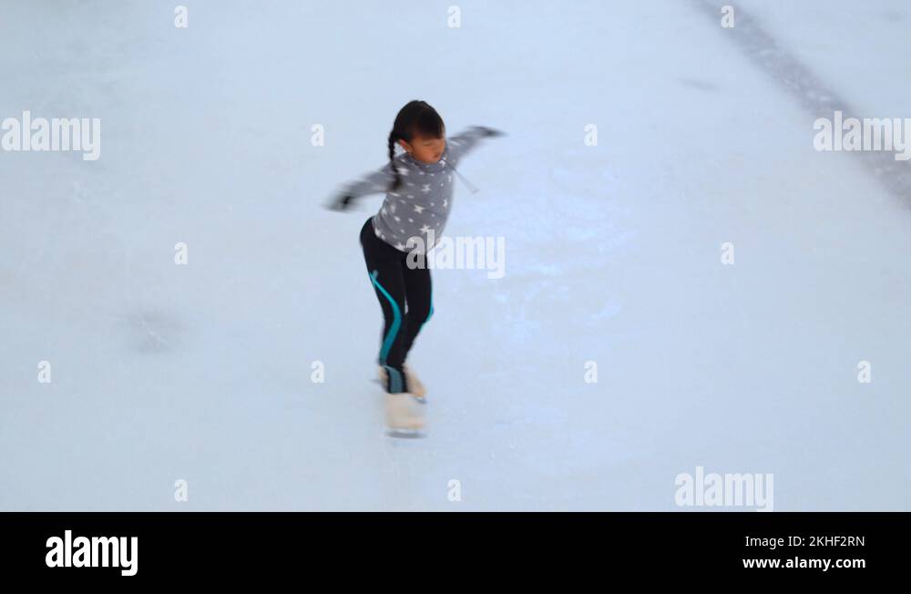 Little girl dancing at indoor ice skating rink Stock Video Footage - Alamy