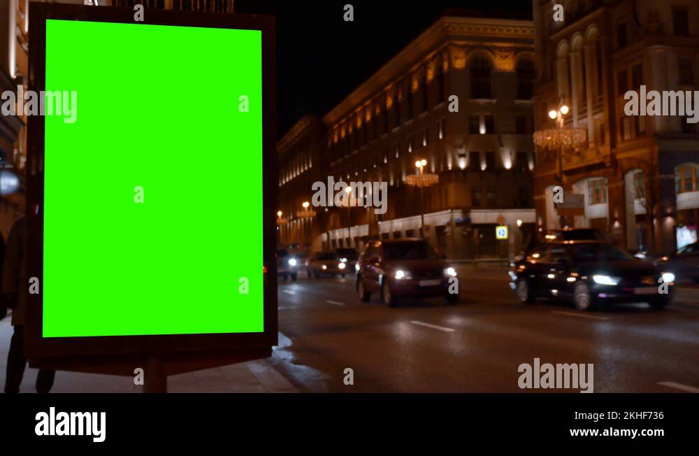 Showcase with a large green screen. Cars are coming. City street ...