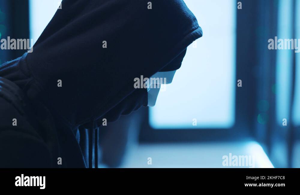 Computer Hacker Sneaking Into Database Server Room Typing Code On
