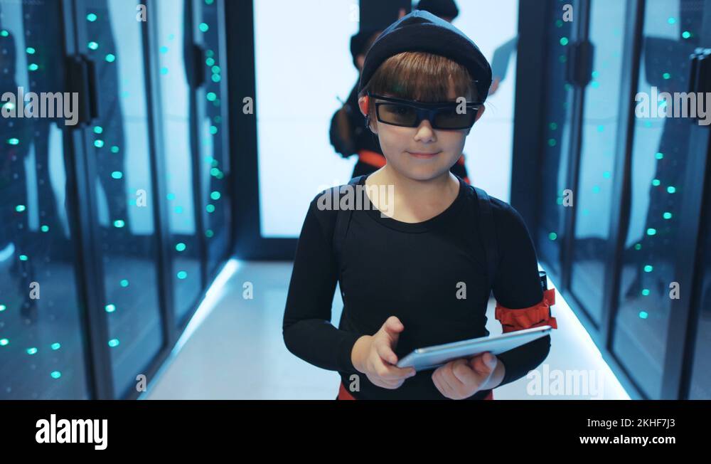 Adorable child dressed as professional spy participating in secret tech ...
