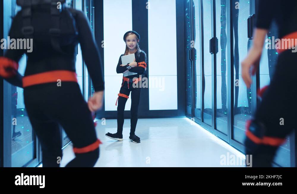 Cheerful spy kids performing a modern cool dance inside server room ...