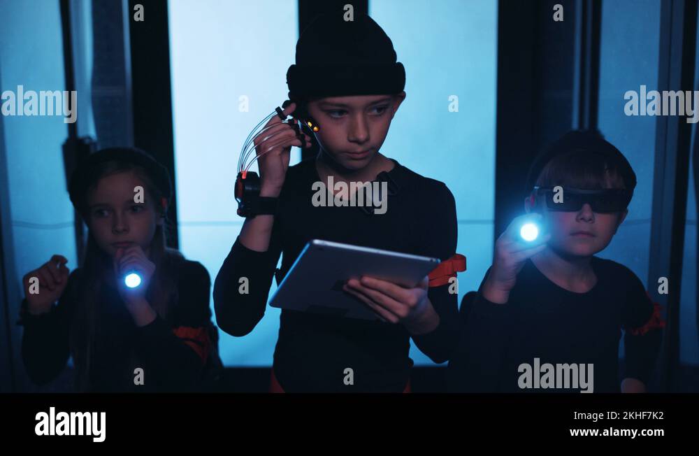 Spy kids. Young team of computer hackers breaking into server room ...