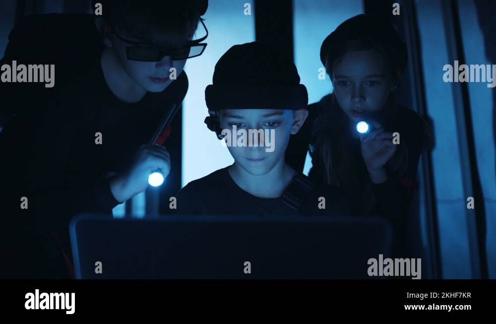 Young cute team of prodigy kids programming in server room. Spy ...