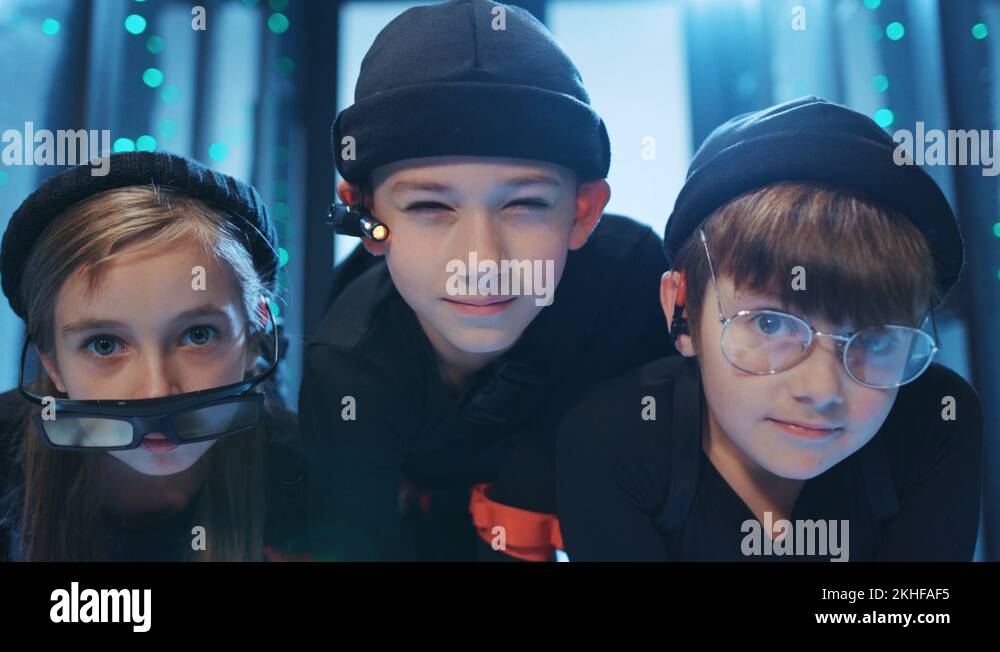 Group portrait of spy kids coding on computer to hack database server ...