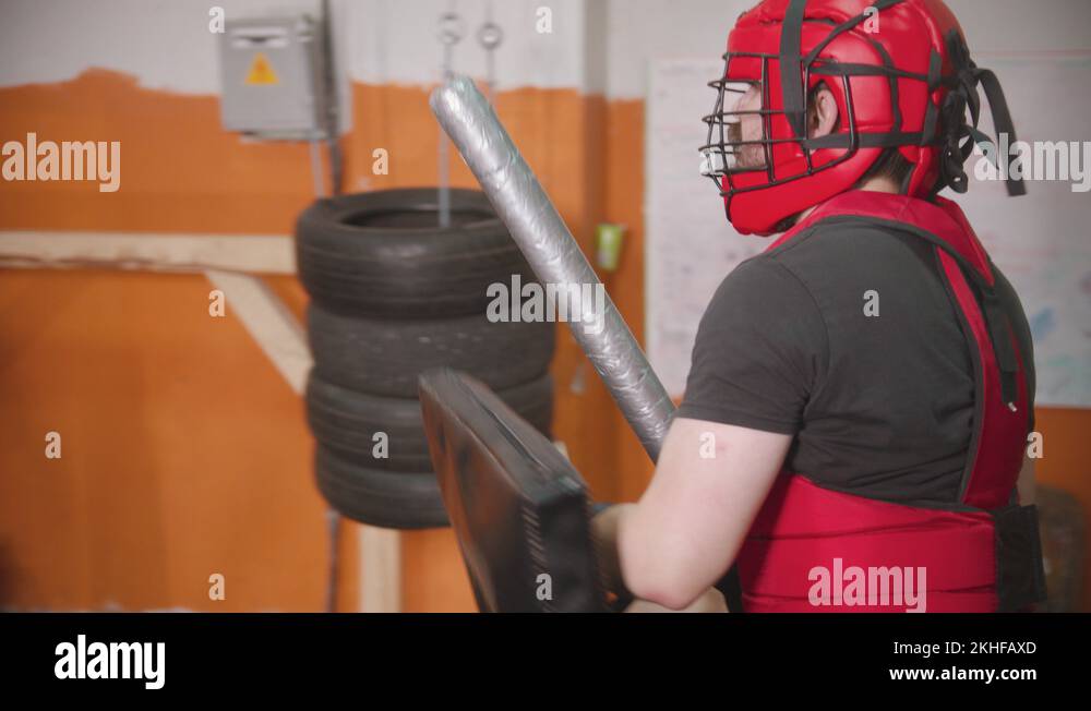 Two men having a training fight in the gym using a safe sword and ...