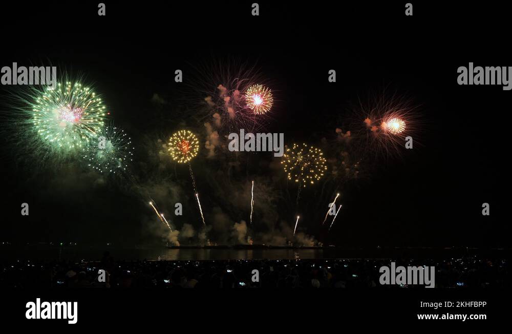 Real fireworks background and people who come to watch on the beach ...