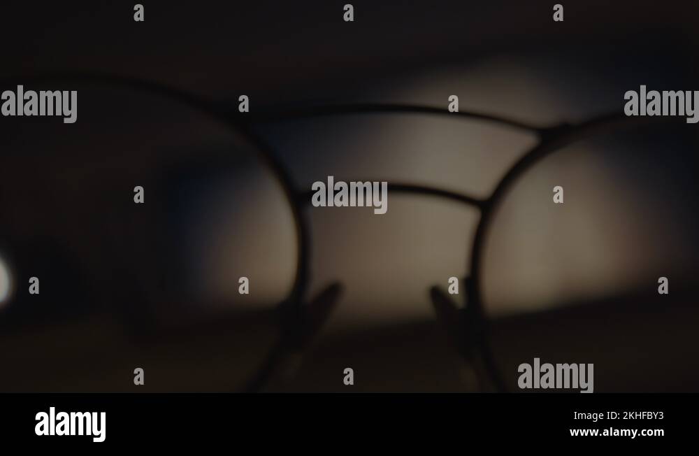 Poor eyesight. Person putting on glasses, badly sees while watching TV ...