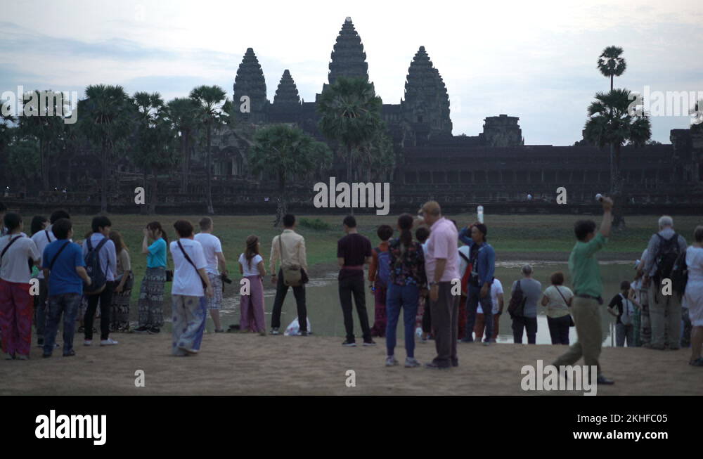 Crowd of people sightseeing ancient Angkor Wat temple ruins in Cambodia ...