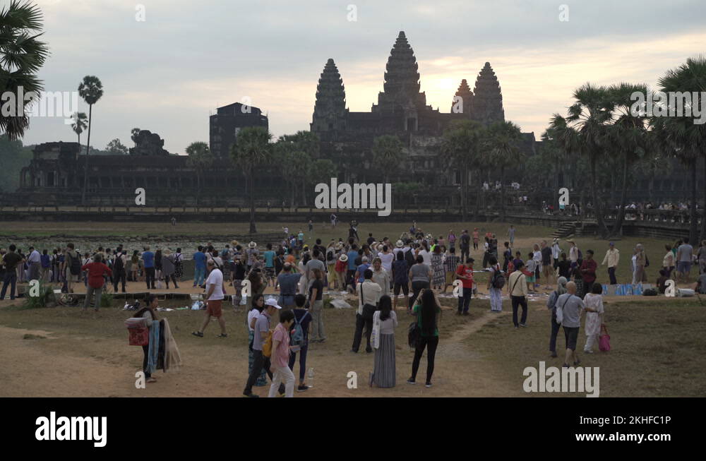Crowd of people sightseeing ancient Angkor Wat temple ruins in Cambodia ...