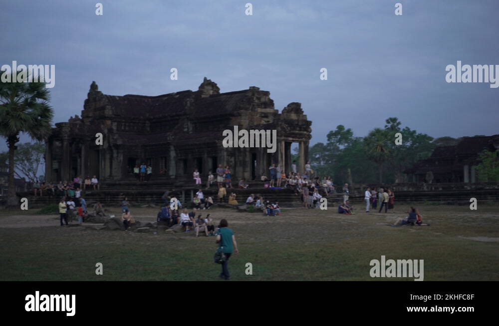 Crowd of people sightseeing ancient Angkor Wat temple ruins in Cambodia ...