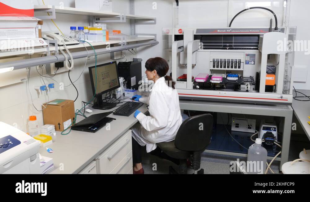 Scientist in a biology gene lab at a pipetting robot Stock Video ...
