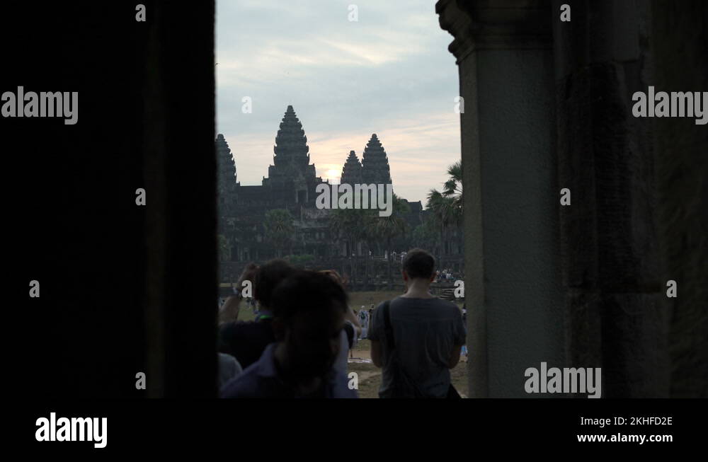 Crowd of people sightseeing ancient Angkor Wat temple ruins in Cambodia ...