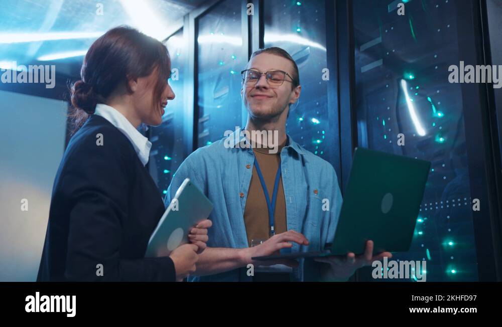 Woman IT supervisor coworking with young server intern praising him for ...