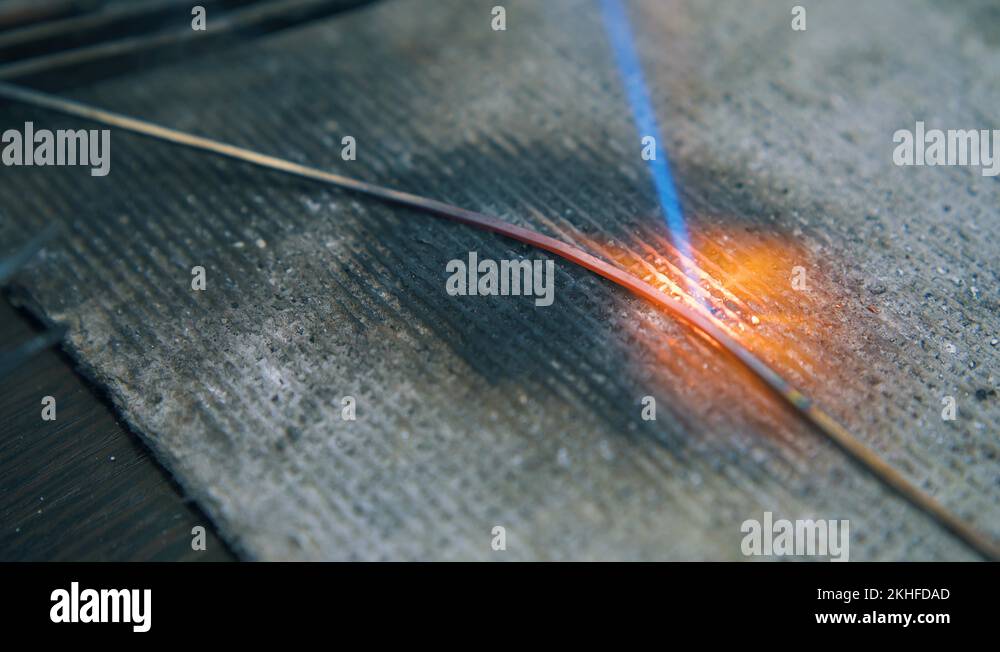 heating of wire with gas burner on fireproof sheet closeup Stock Video ...