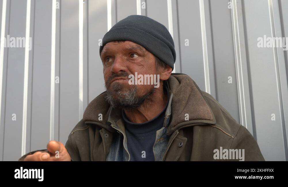 Homeless man with toothless mouth trying to eat an apple Stock Video ...