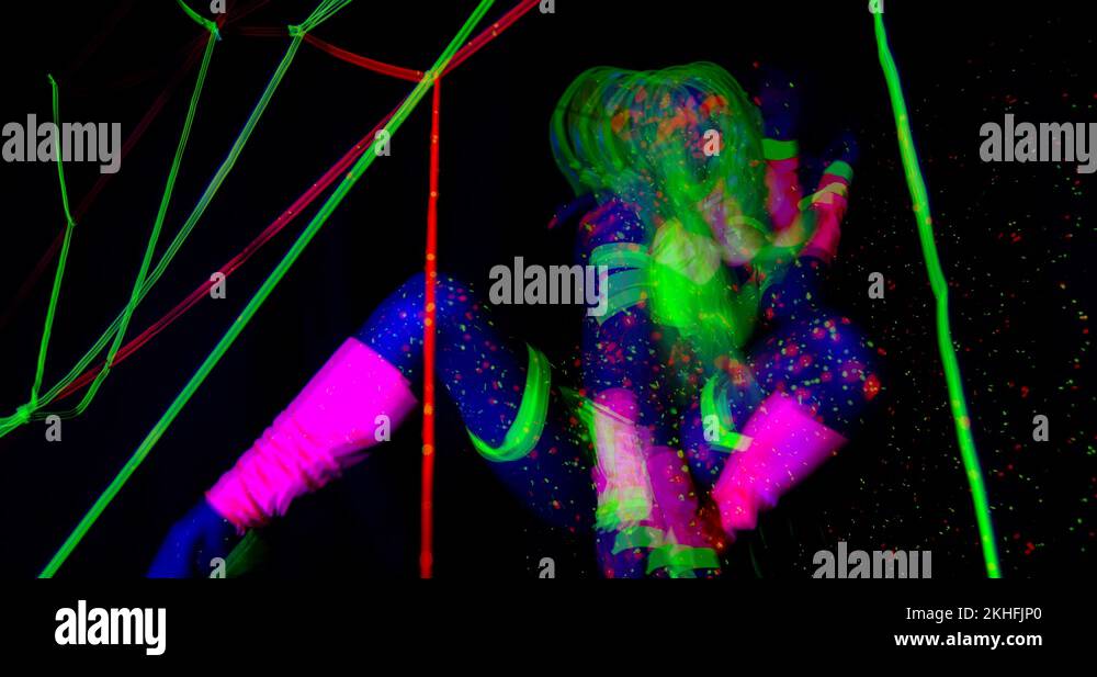 Glowing clothes and hair on a woman dancing in uv light, trippy effect ...