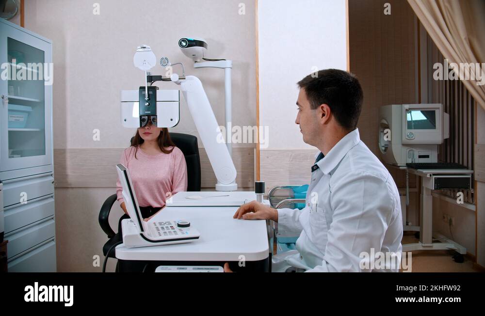 Ophthalmology treatment - young woman checking her visual acuity on an ...