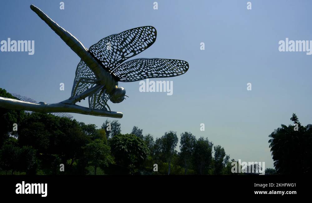 Left to right pan from an iron dragonfly statue to the famed landmark ...