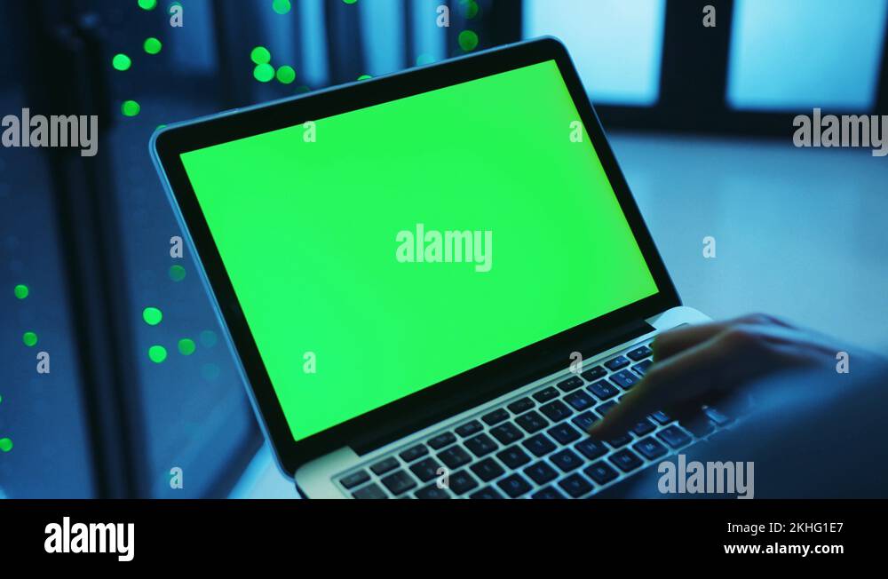 Database worker using green laptop mock-up for diagnostics, running ...