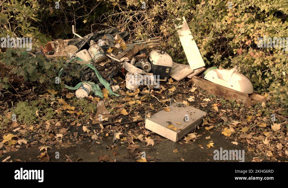 Fly tipped waste by an abandoned building in a post apocalyptic setting ...