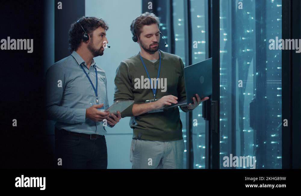 IT professional team of support engineers analyzing server room of ...