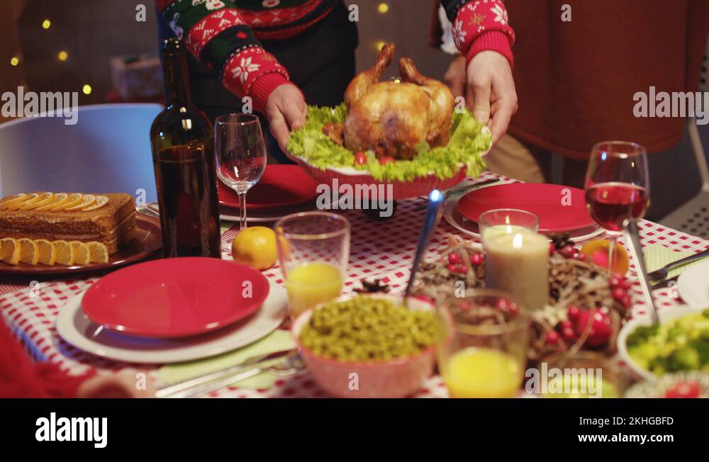 Father putting hot turkey on dinner table sitting with big family. Kids ...